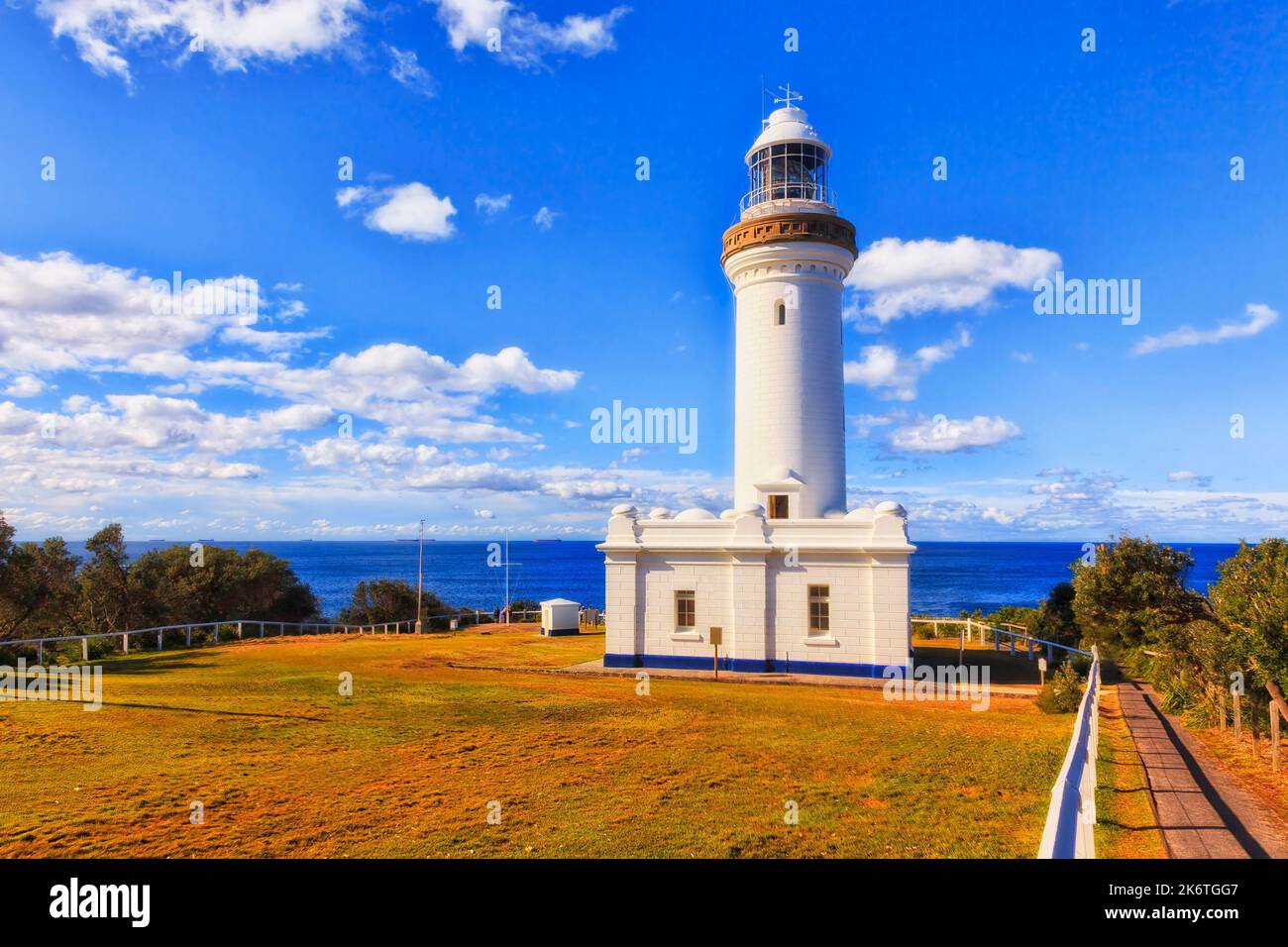 White historic lighthouse tower on Norah head of Australian pacific ...