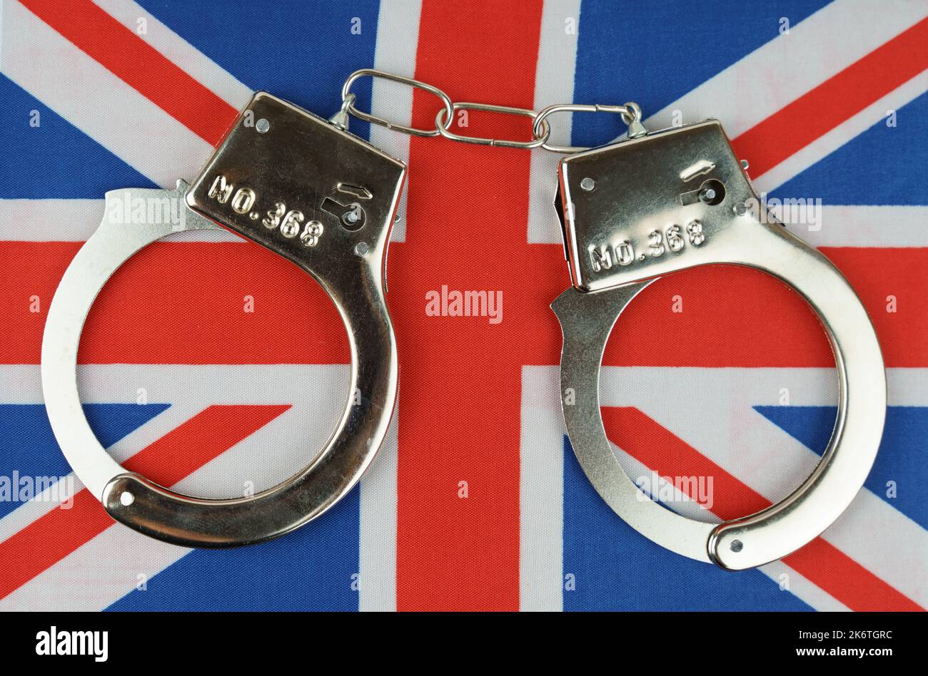 The concept of law and crime. There are handcuffs on the UK flag Stock ...