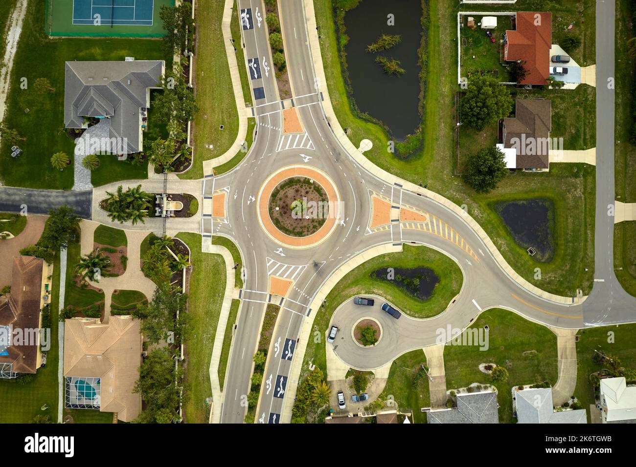 Aerial view of road roundabout intersection with moving cars traffic ...