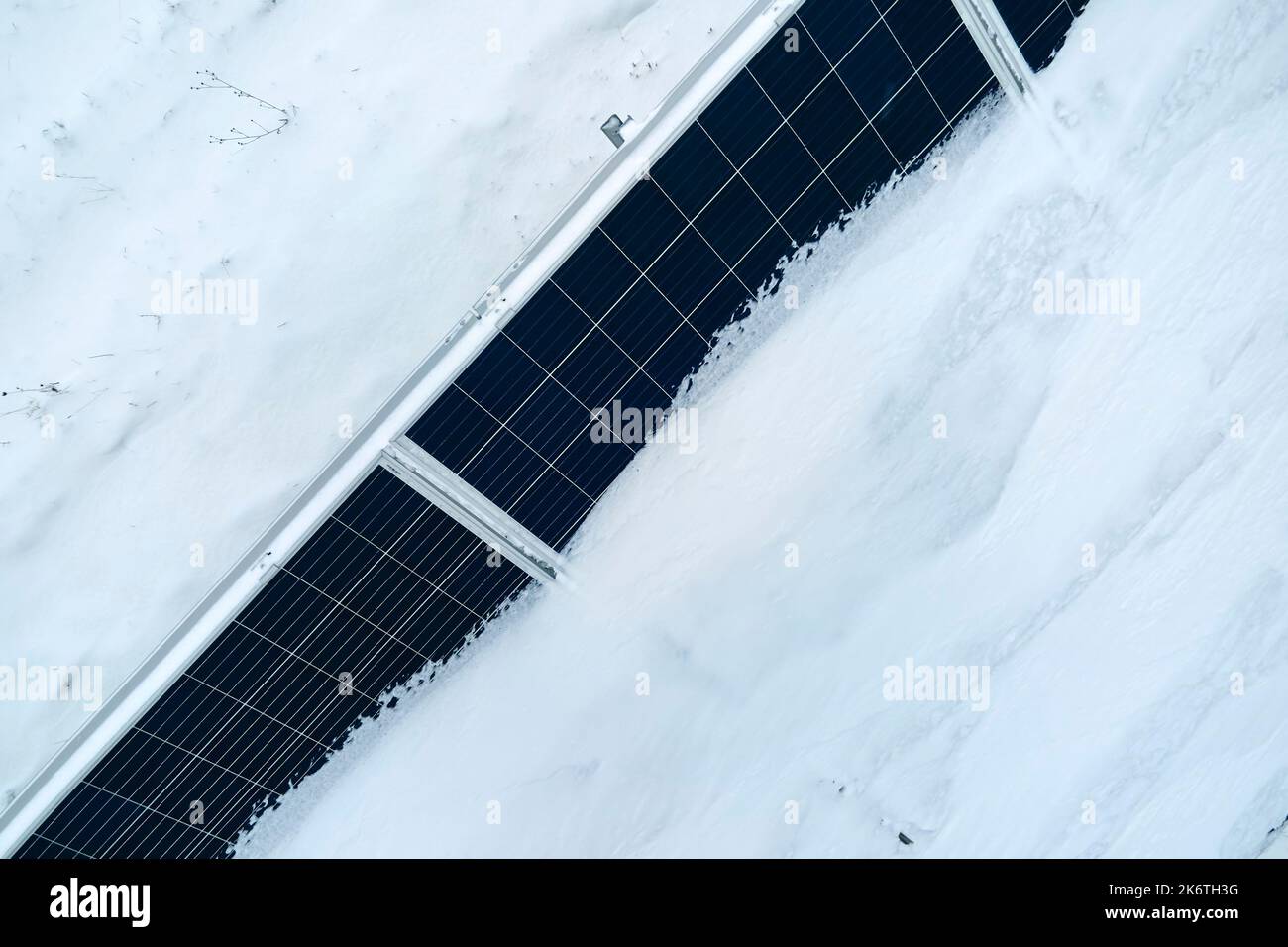 Aerial view of snow covered sustainable electric power plant with rows ...