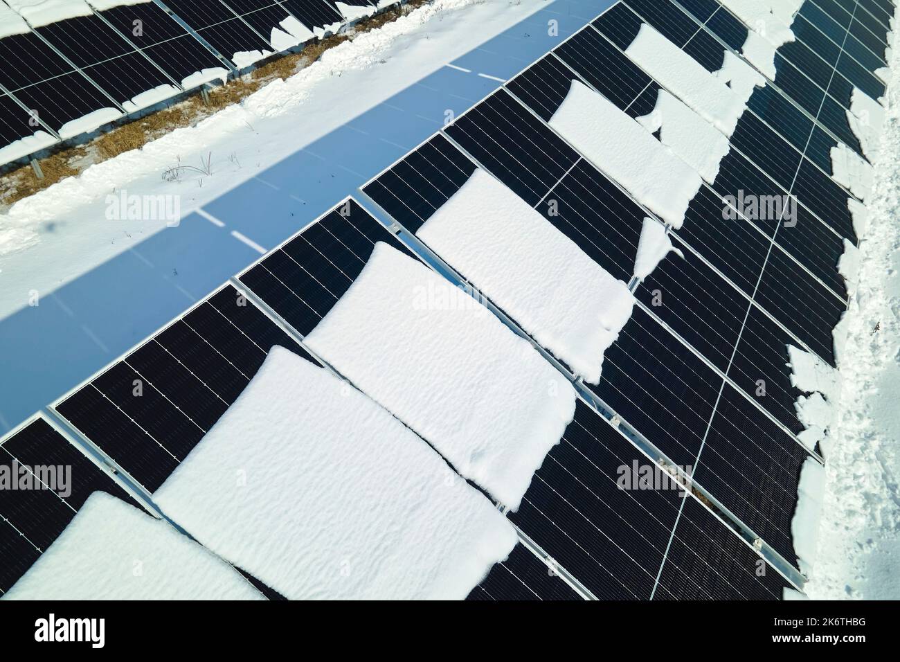 Aerial view of snow melting from covered solar photovoltaic panels at ...