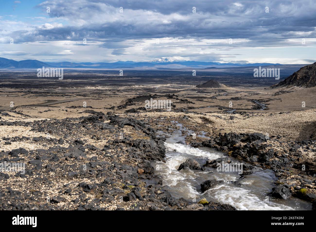 River flows through volcanic landscape, volcanic rocks and tuff, barren ...