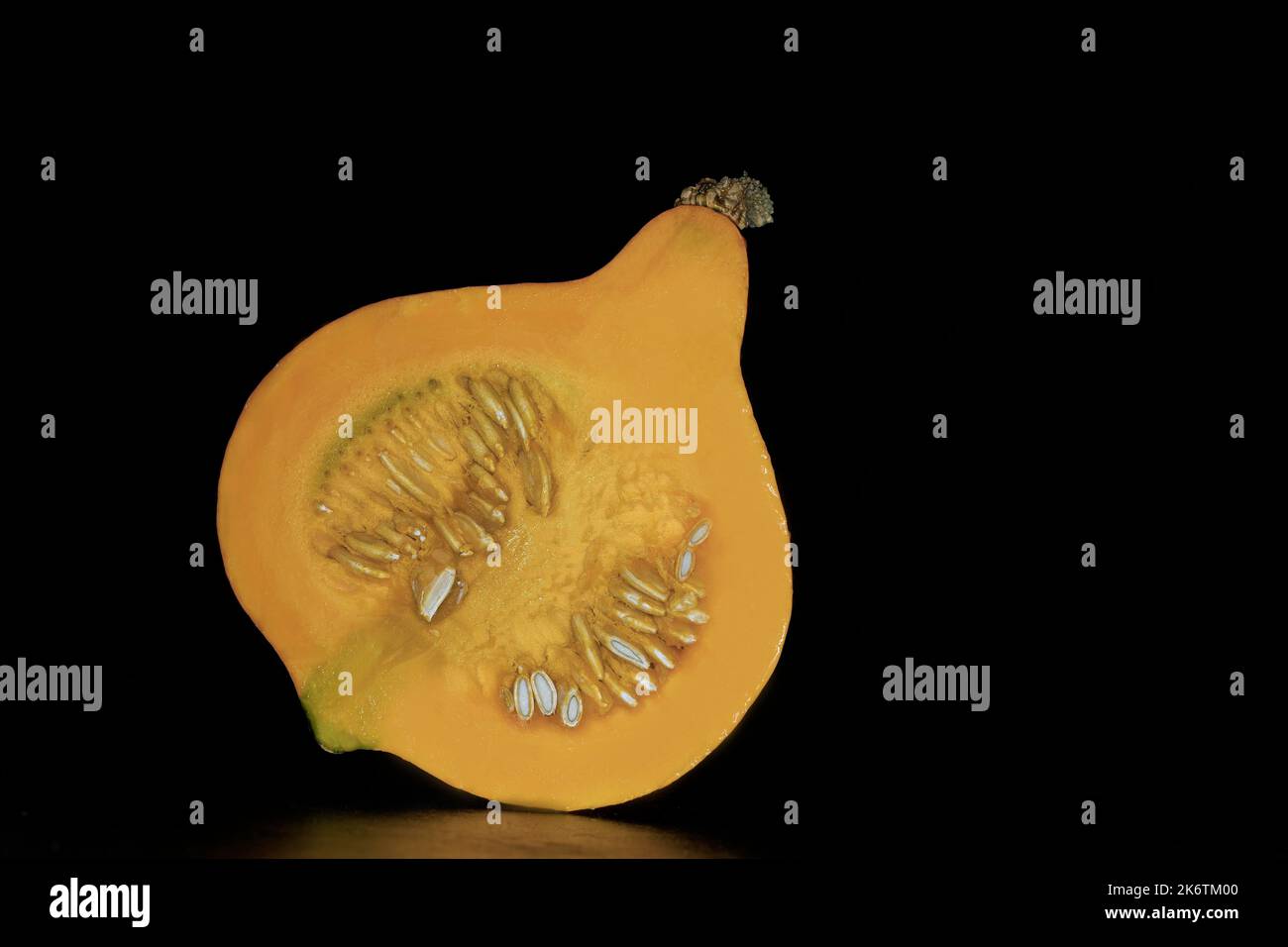 Halved squash (Cucurbita maxima), food photography with black ...