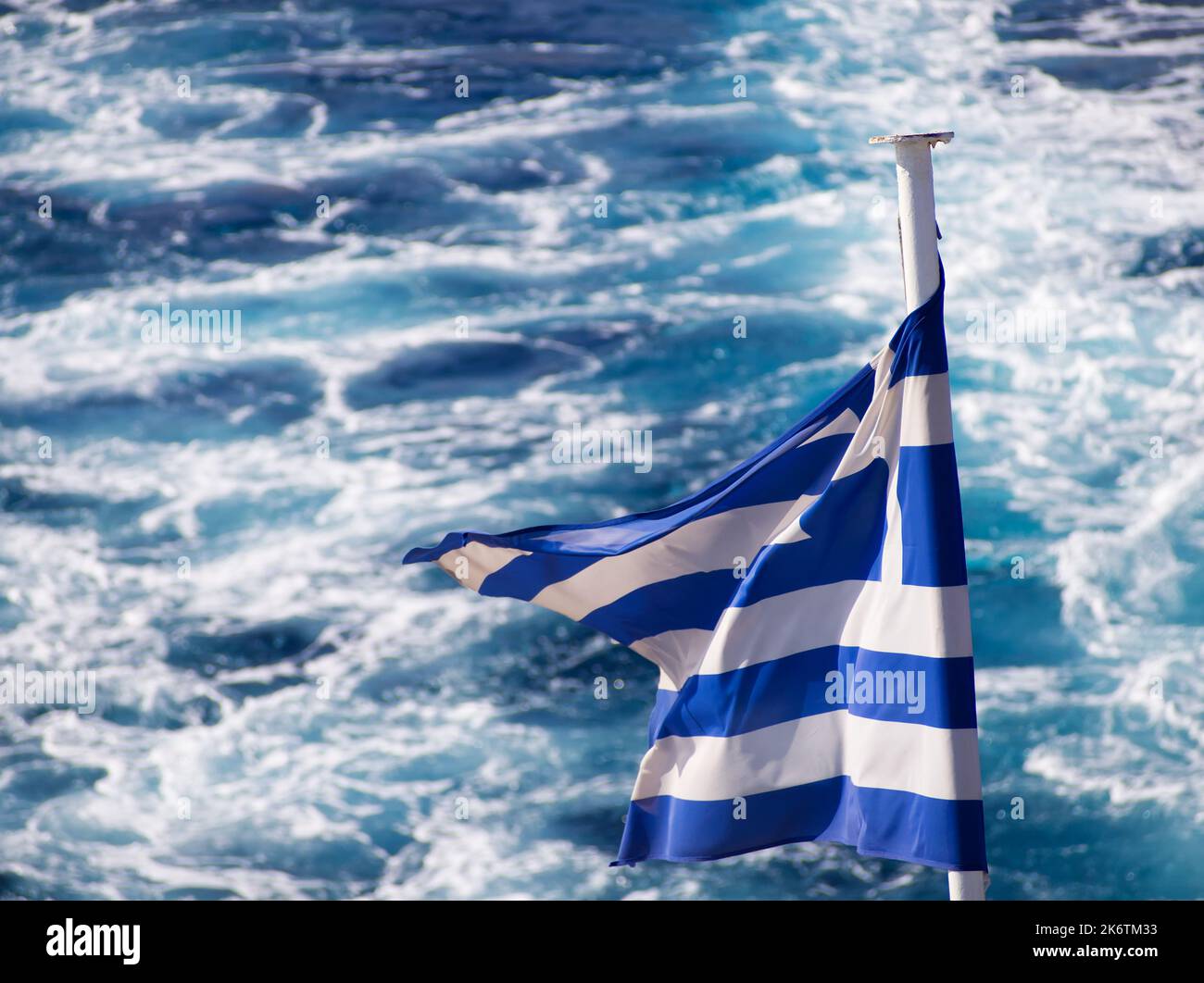 Greek flag on boat over waves Stock Photo - Alamy