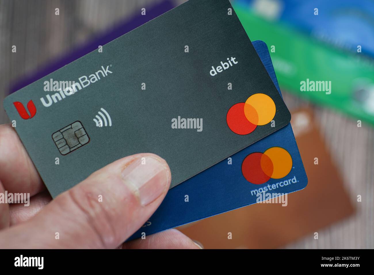 Overhead view of man holding debit and credit cards with more card ...