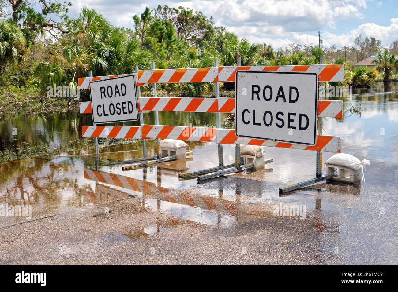 Hurricane Ian flooded street with road closed signs blocking driving of ...