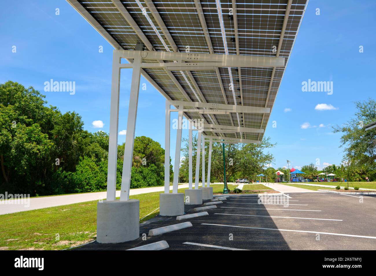 Solar panels installed as shade roof over parking lot for parked ...