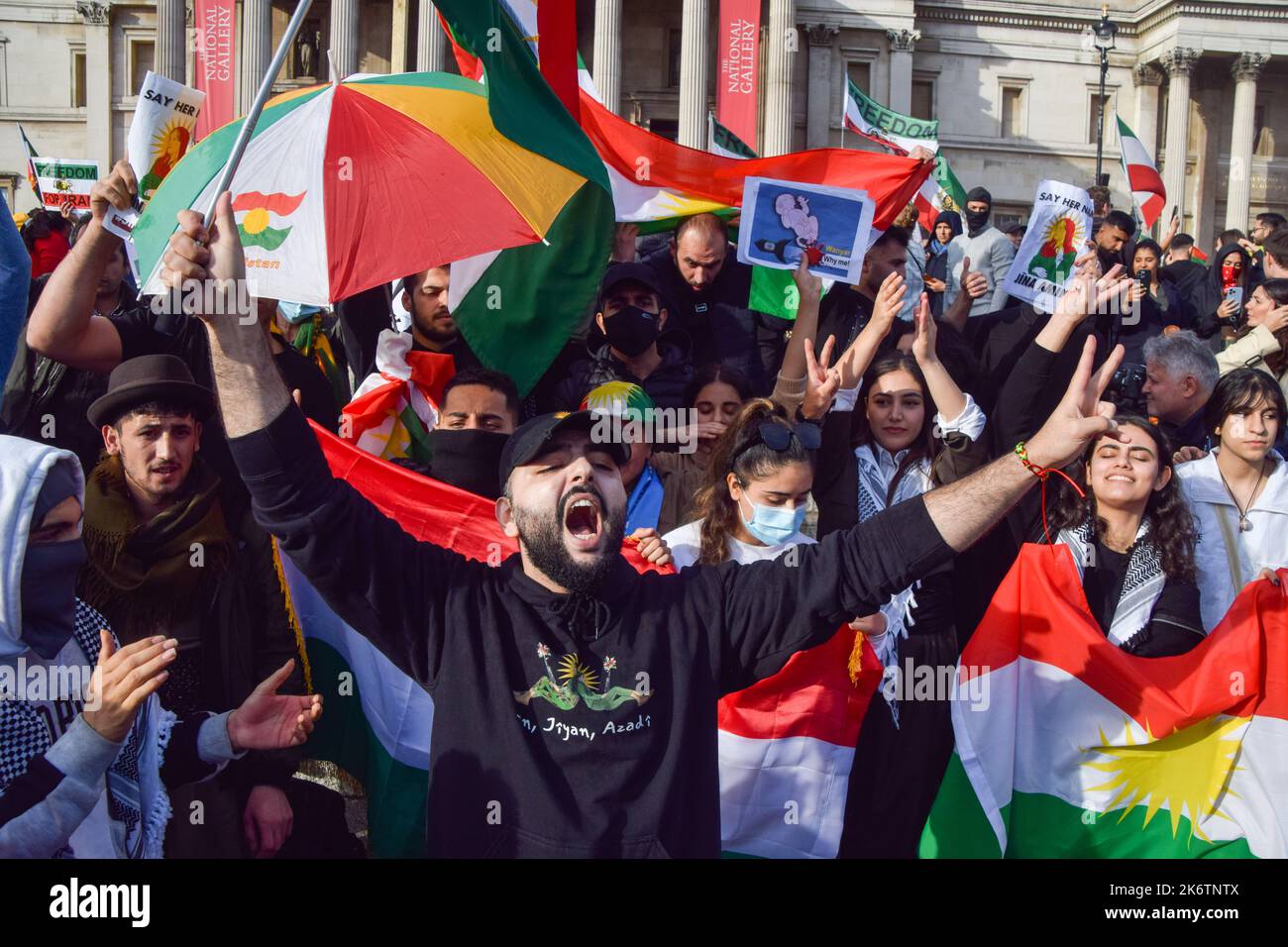 London, UK. 15th Oct, 2022. Protesters hold Iranian flags while ...
