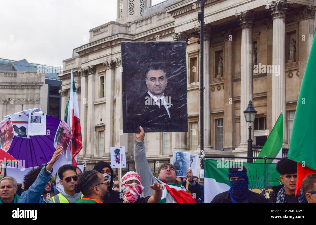 London, UK. 15th Oct, 2022. A protester holds a picture of Reza Pahlavi ...