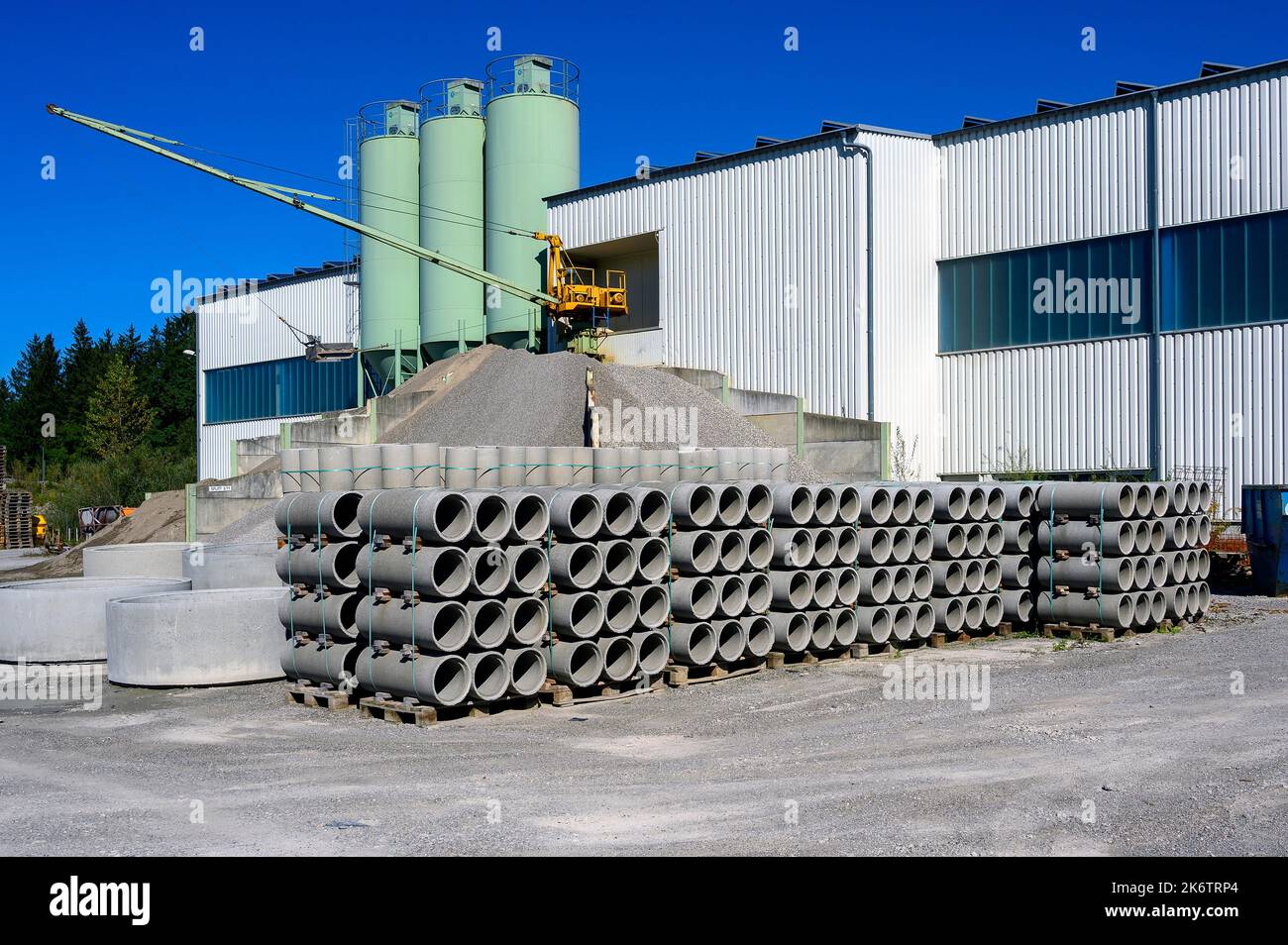 Steel silos and shovel crane, concrete pipes, precast concrete plant ...
