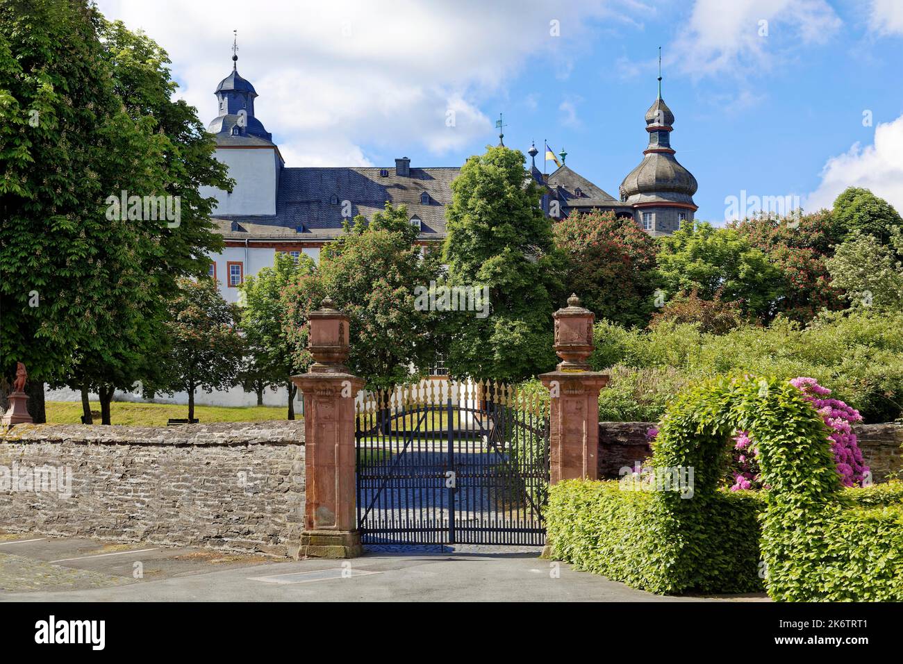 Hedge, wall and wrought-iron gate in front of Berleburg Castle ...