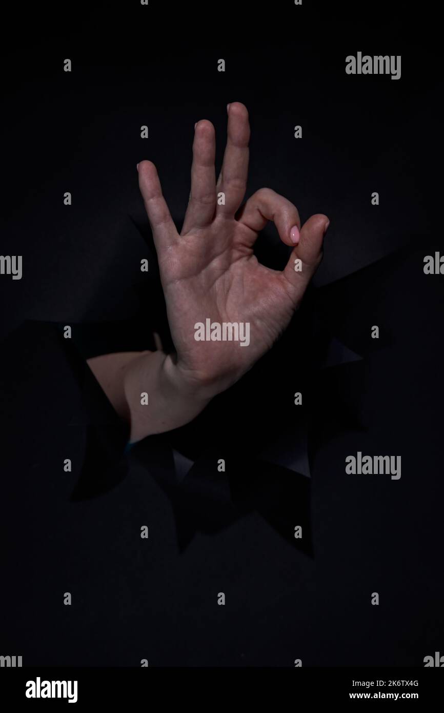 Woman hand over black isolated background showing approval Stock Photo ...