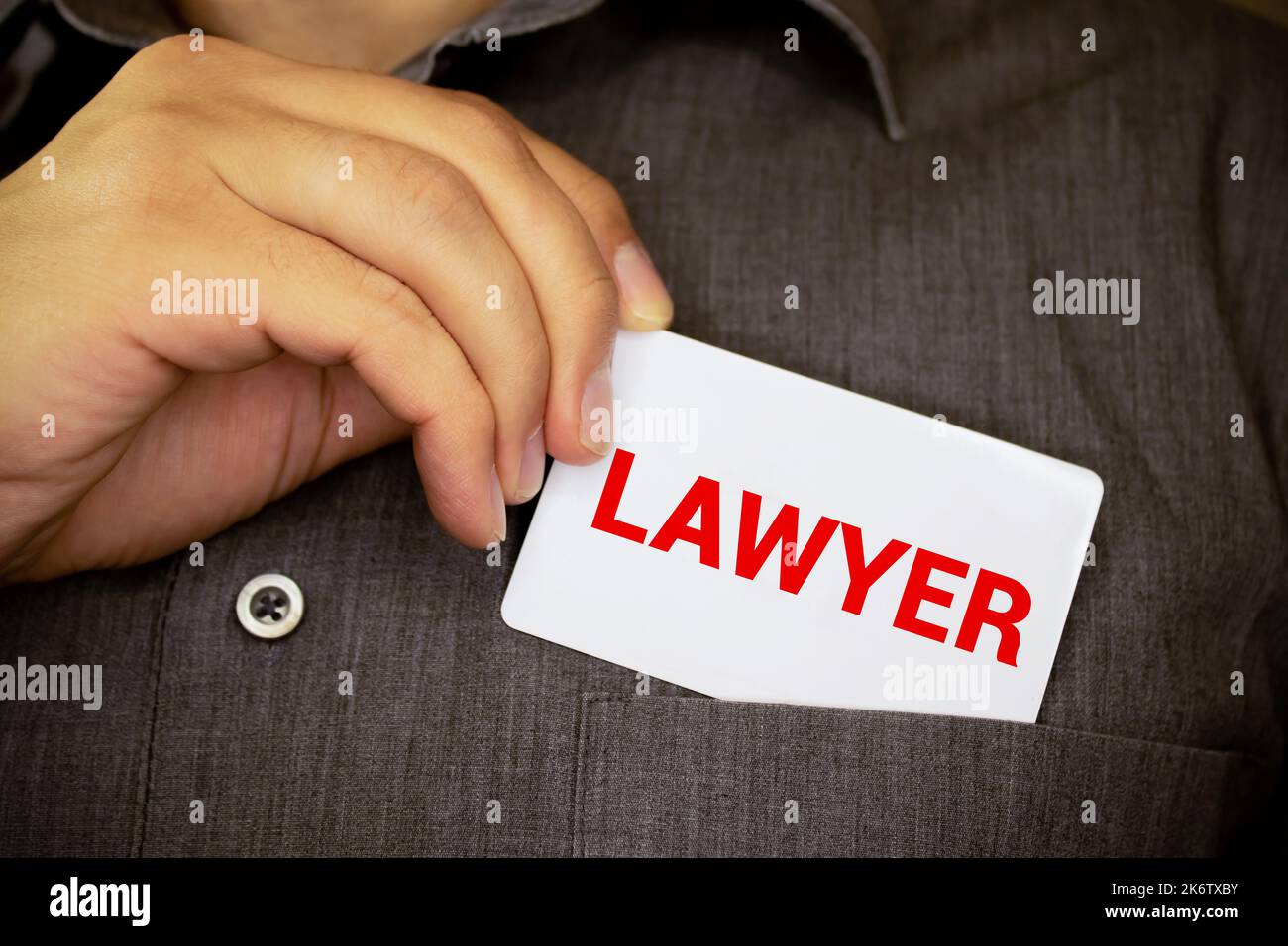 Hand showing card with LAWYER word Stock Photo - Alamy