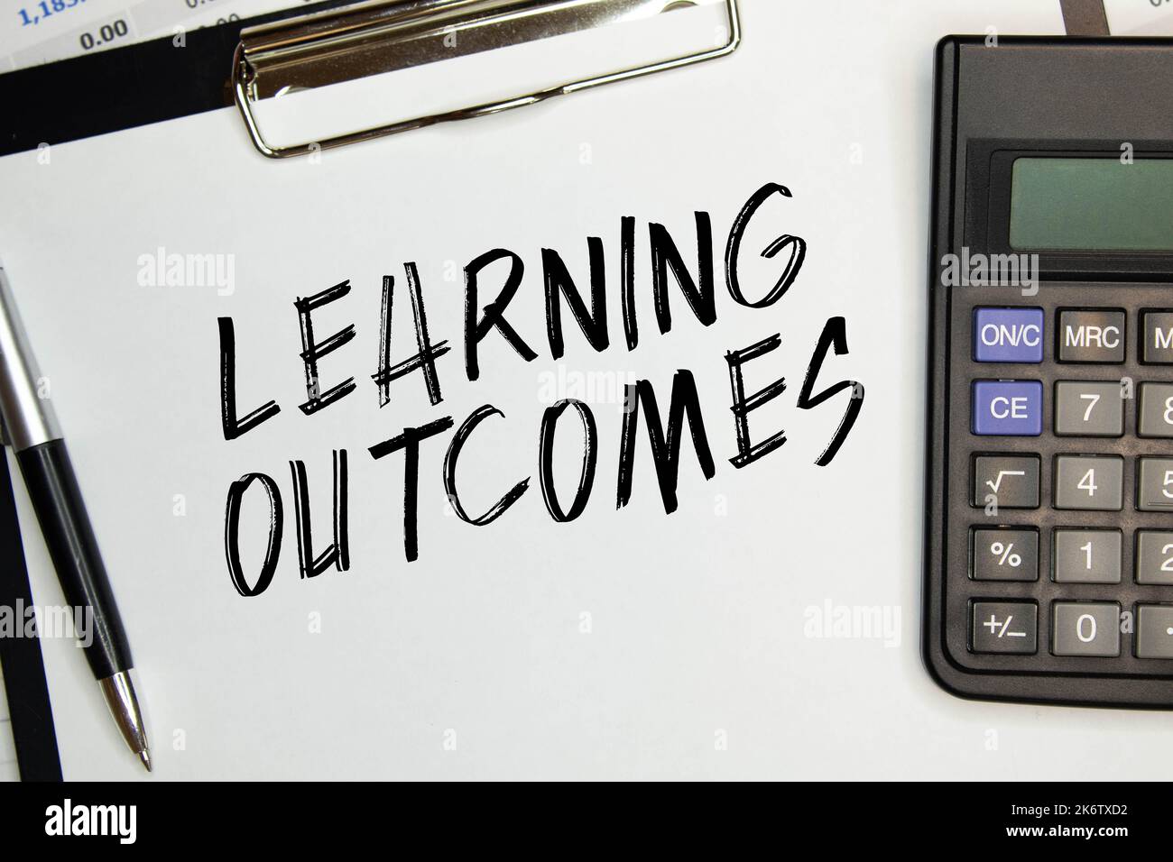 Notepad with text Learning outcomes and wooden cubes with letters Stock ...