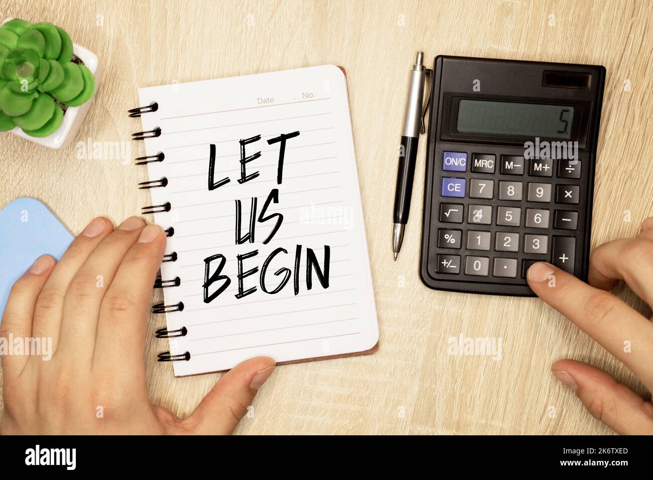 The text Let us get started with red notebook aside isolated on a white ...