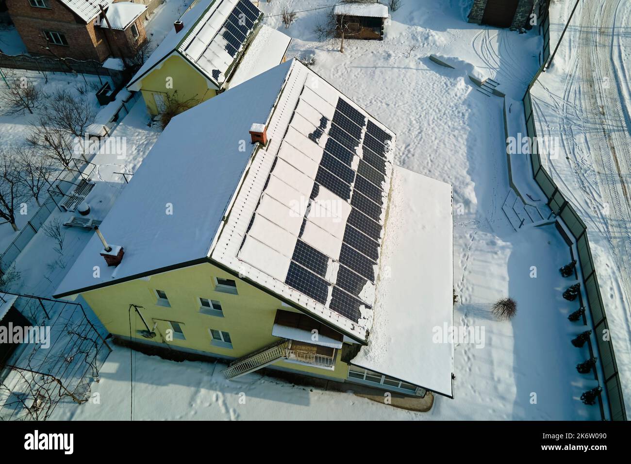 Aerial view of snow melting from covered solar photovoltaic panels ...