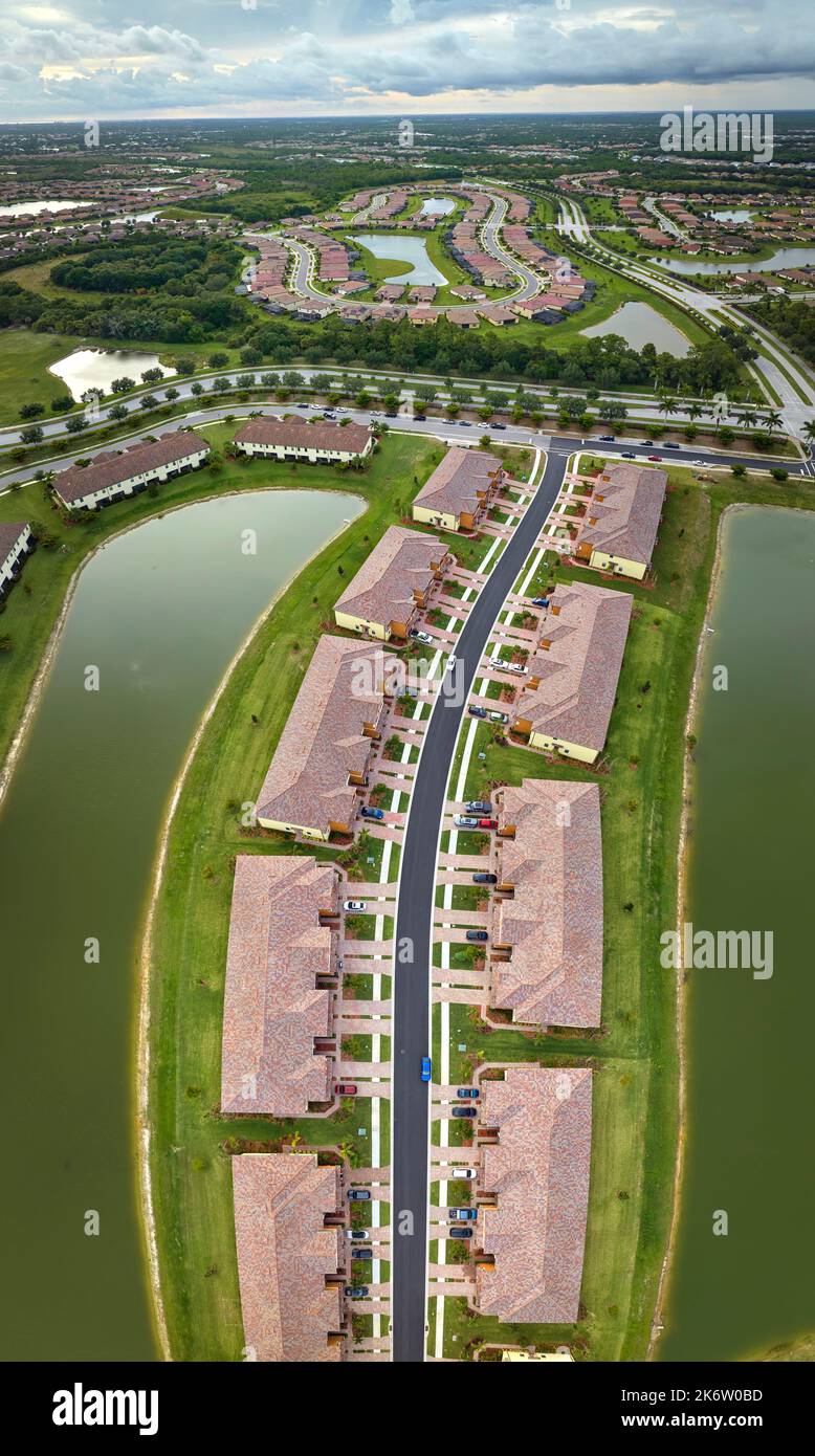 Aerial view of tightly located family houses with retention ponds to ...