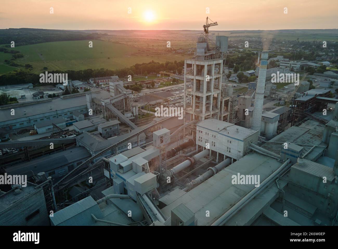 Cement plant with high factory structure and tower cranes at industrial ...