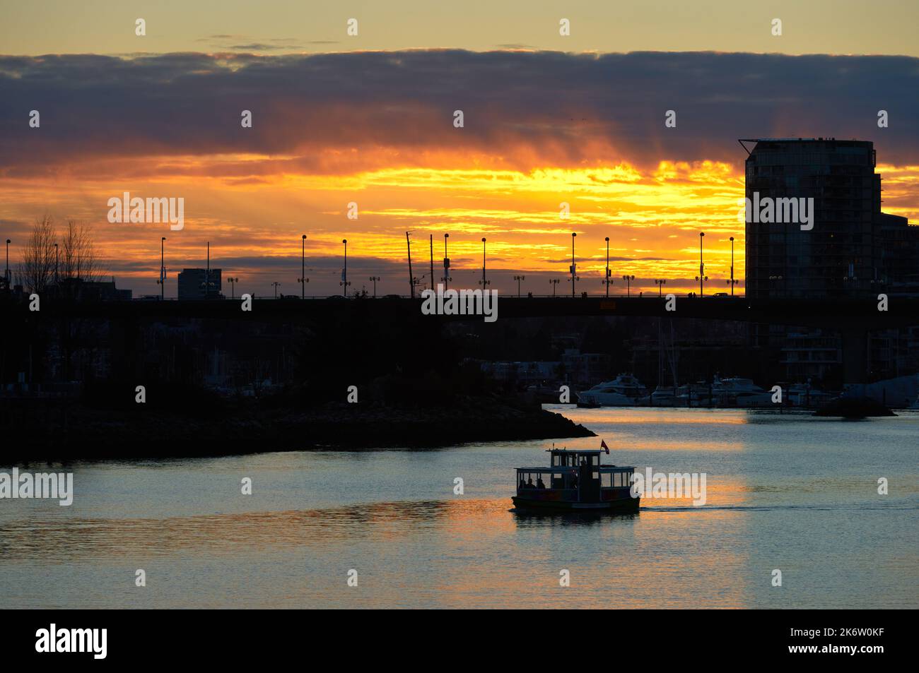 False Creek Commuter Ferry at Sunset. A commuter ferry crosses False ...