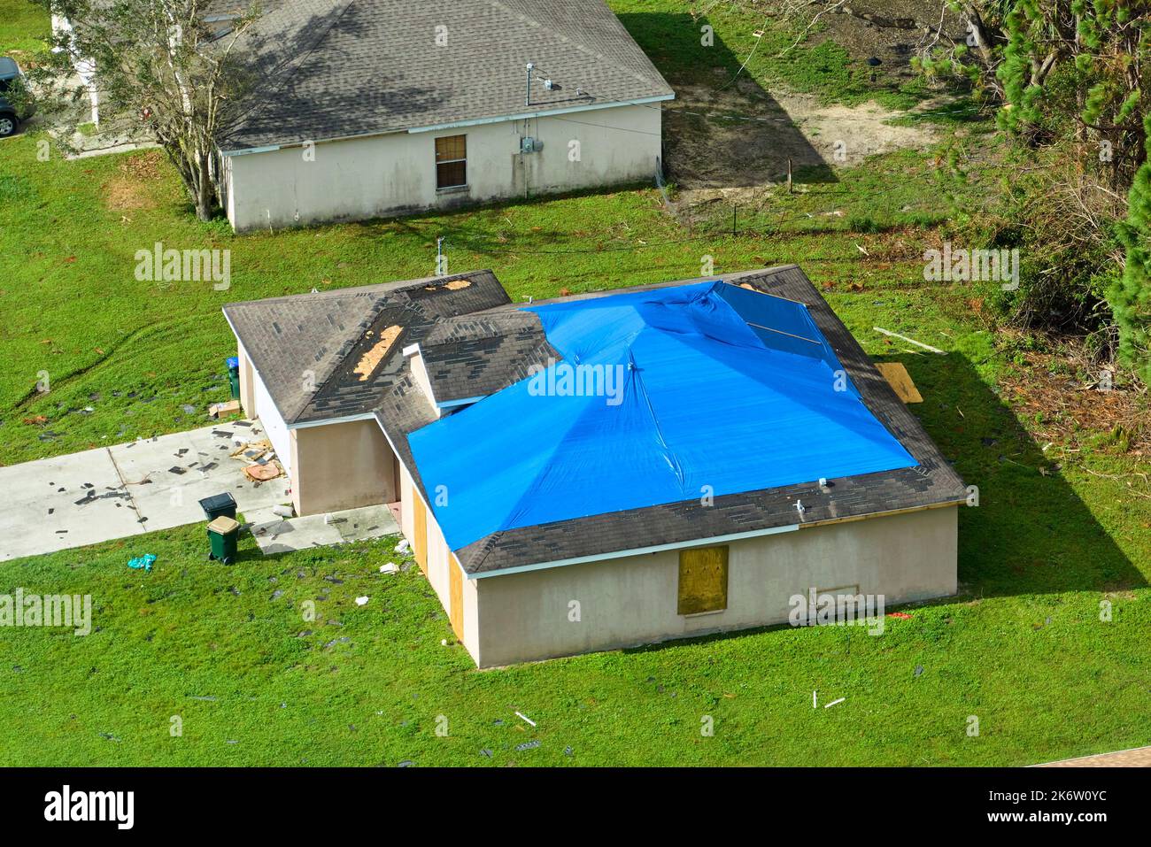 Top view of leaking house roof covered with protective tarp sheets ...