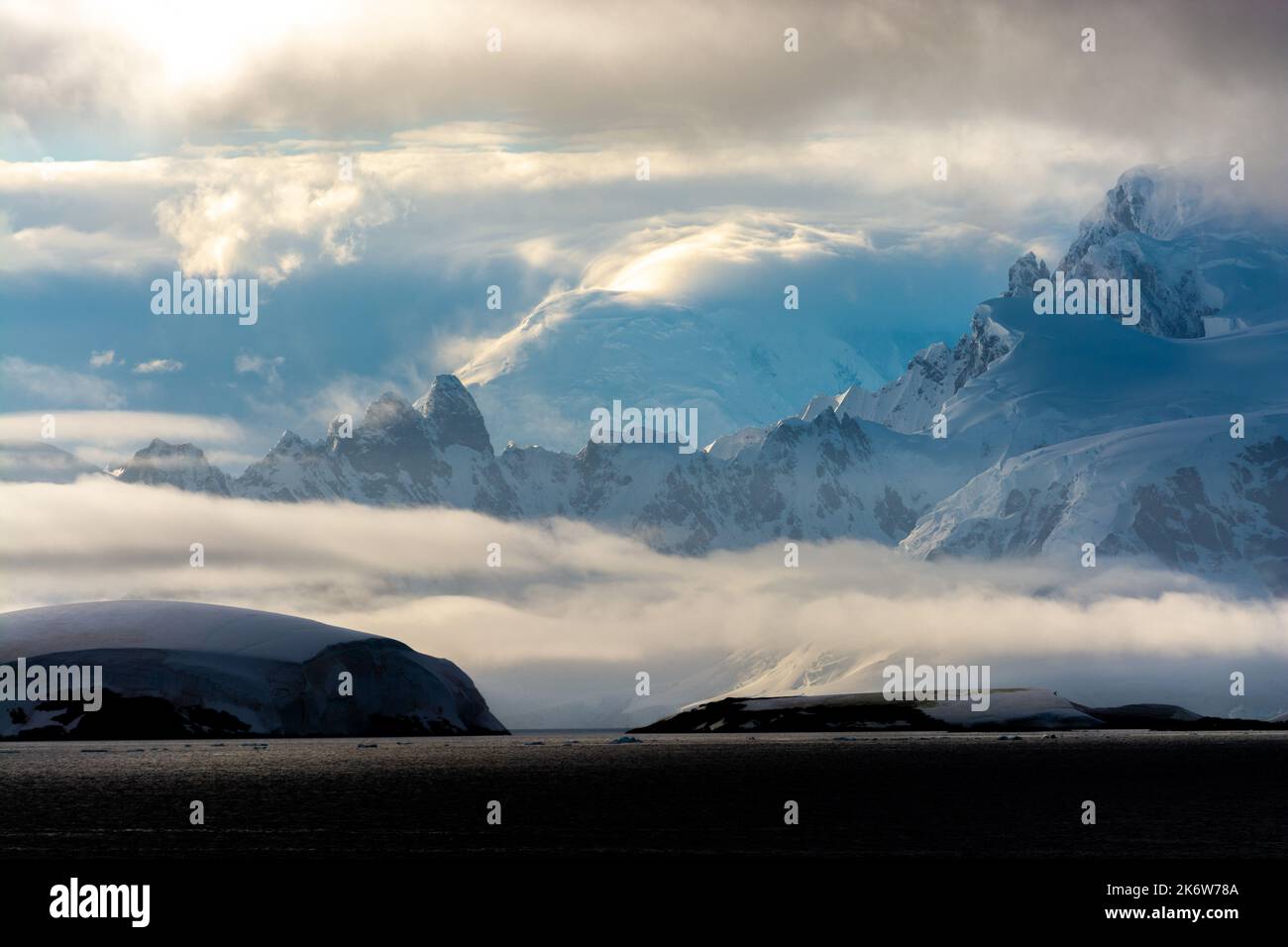 early morning backlit view from dallmann bay of antarctic peninsula ...