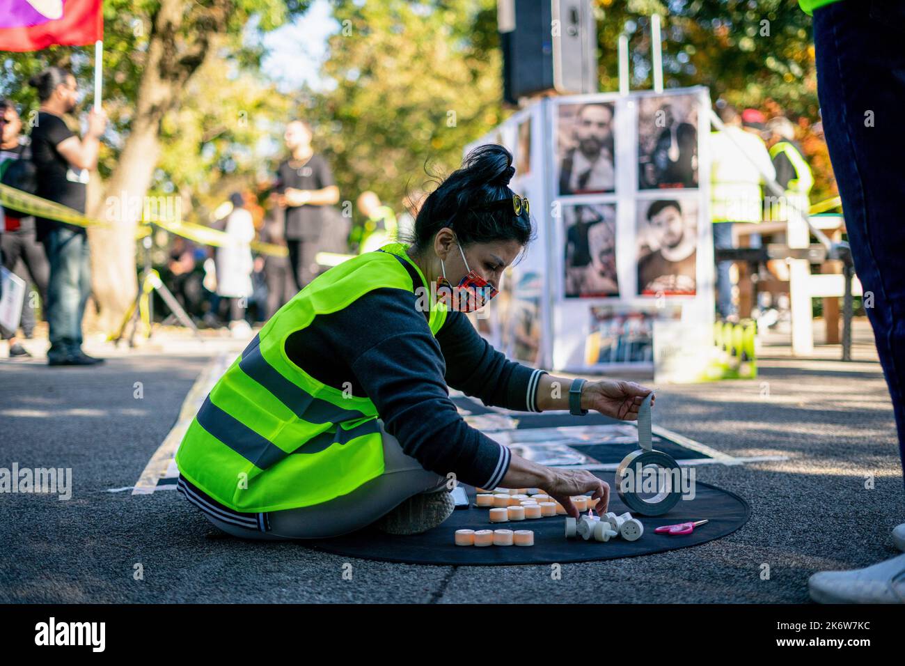 A woman creates a memorial to honor the Masha Amini in Stanton Park ...