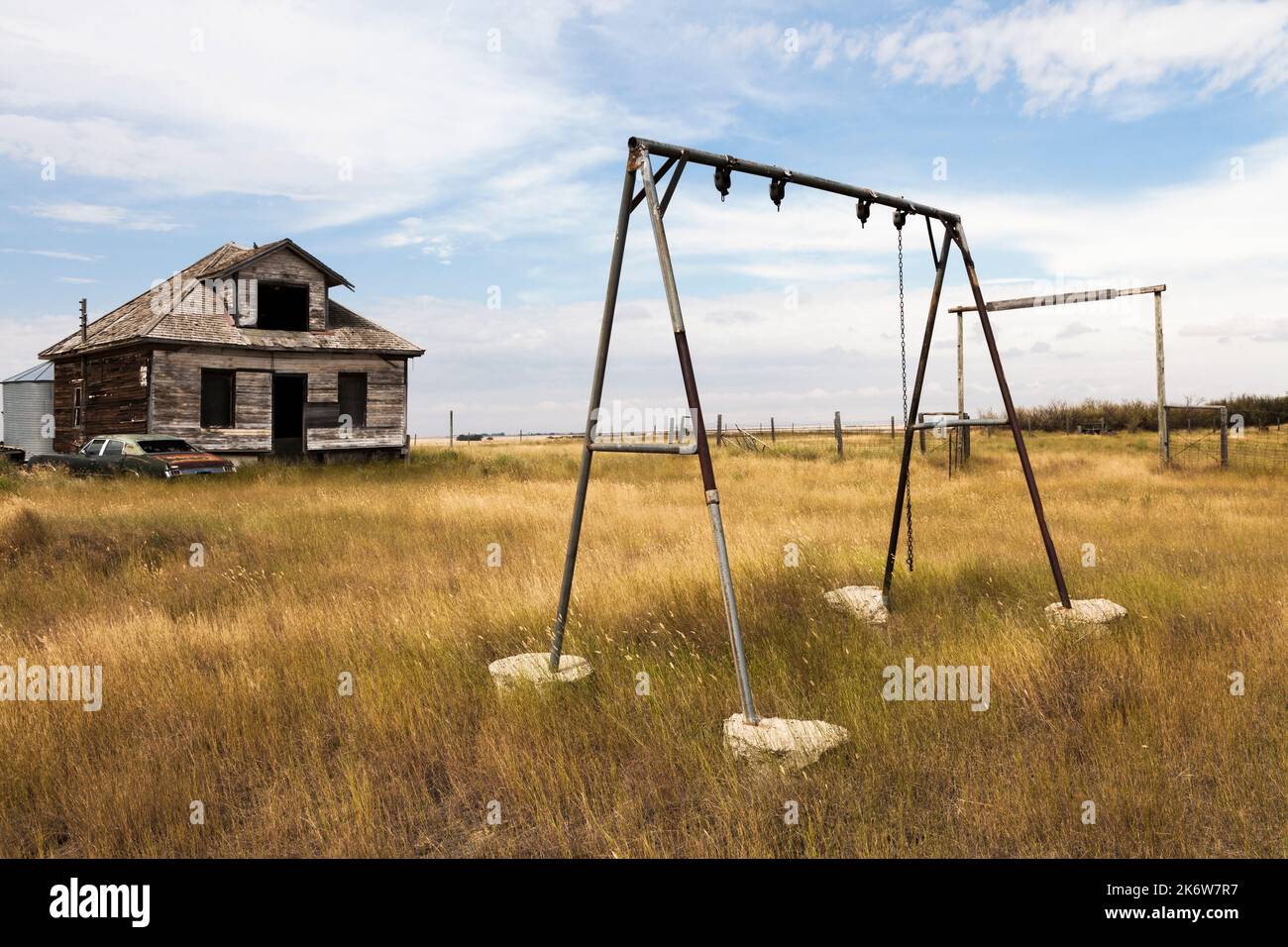 Abandoned swing set in the playground of the public school at the ghost ...