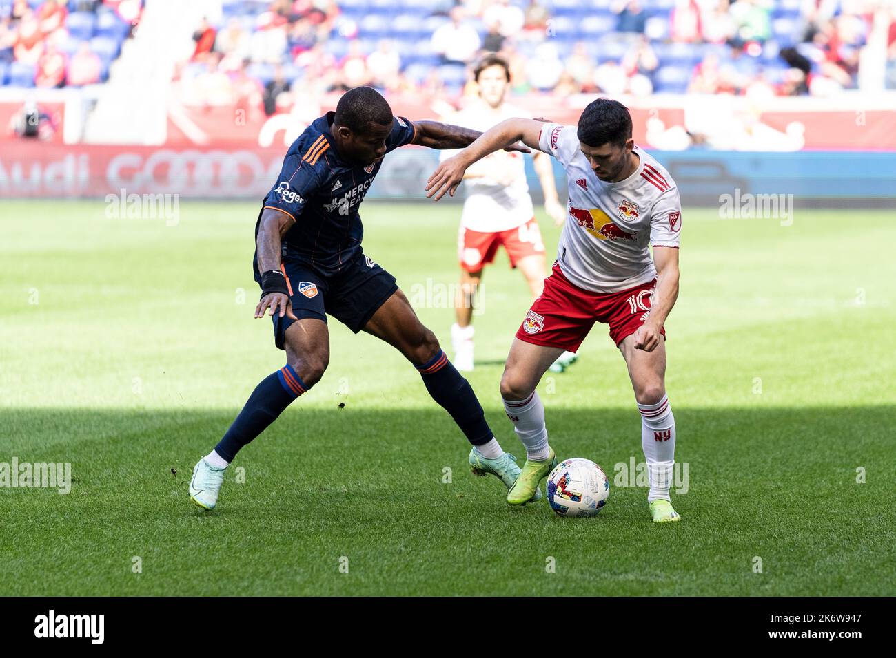 Alvas Powell (2) of FC Cincinnati and Lewis Morgan (10) of Red Bulls ...