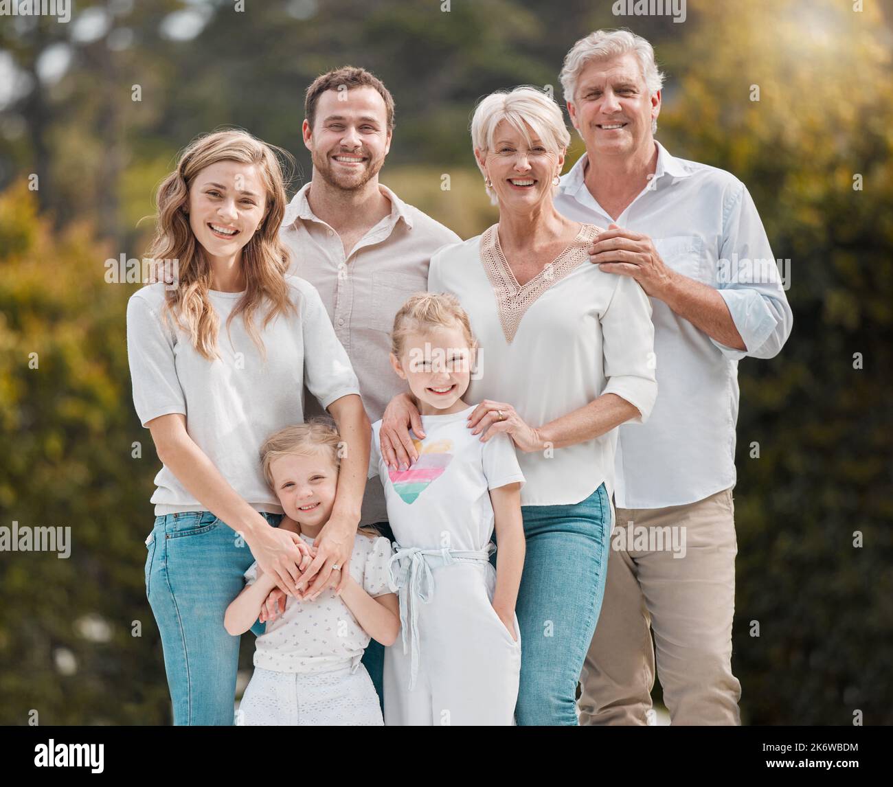 Happy family standing outside in the garden. Smiling senior man and ...