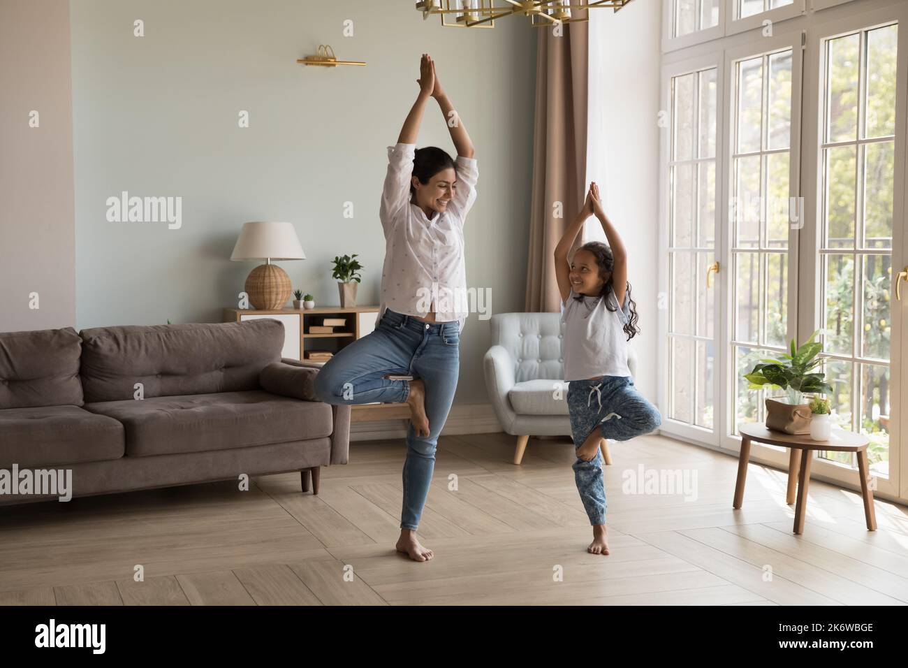 Full-length Indian mum and preschooler daughter practicing Tree asana ...