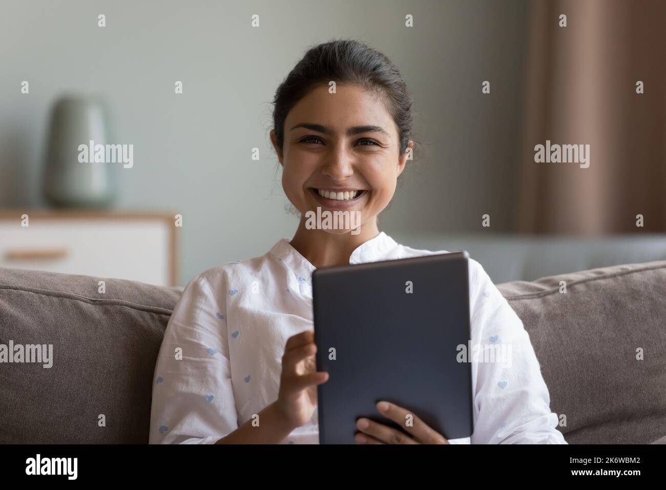 Happy Indian woman using digital tablet smile staring at camera Stock ...