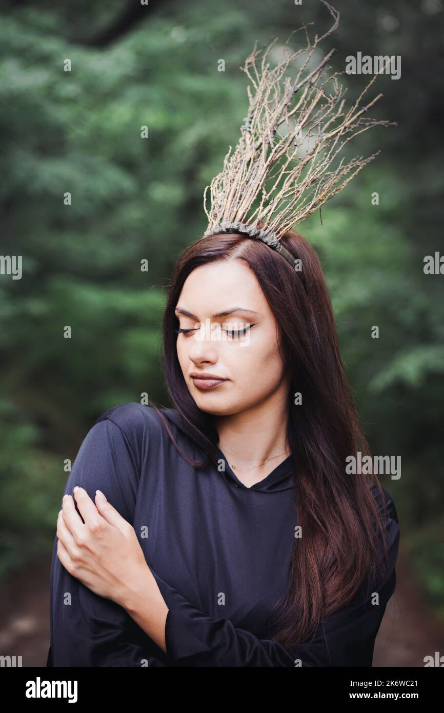 A beautiful young fairy in a crown of branches. Halloween concept Stock ...