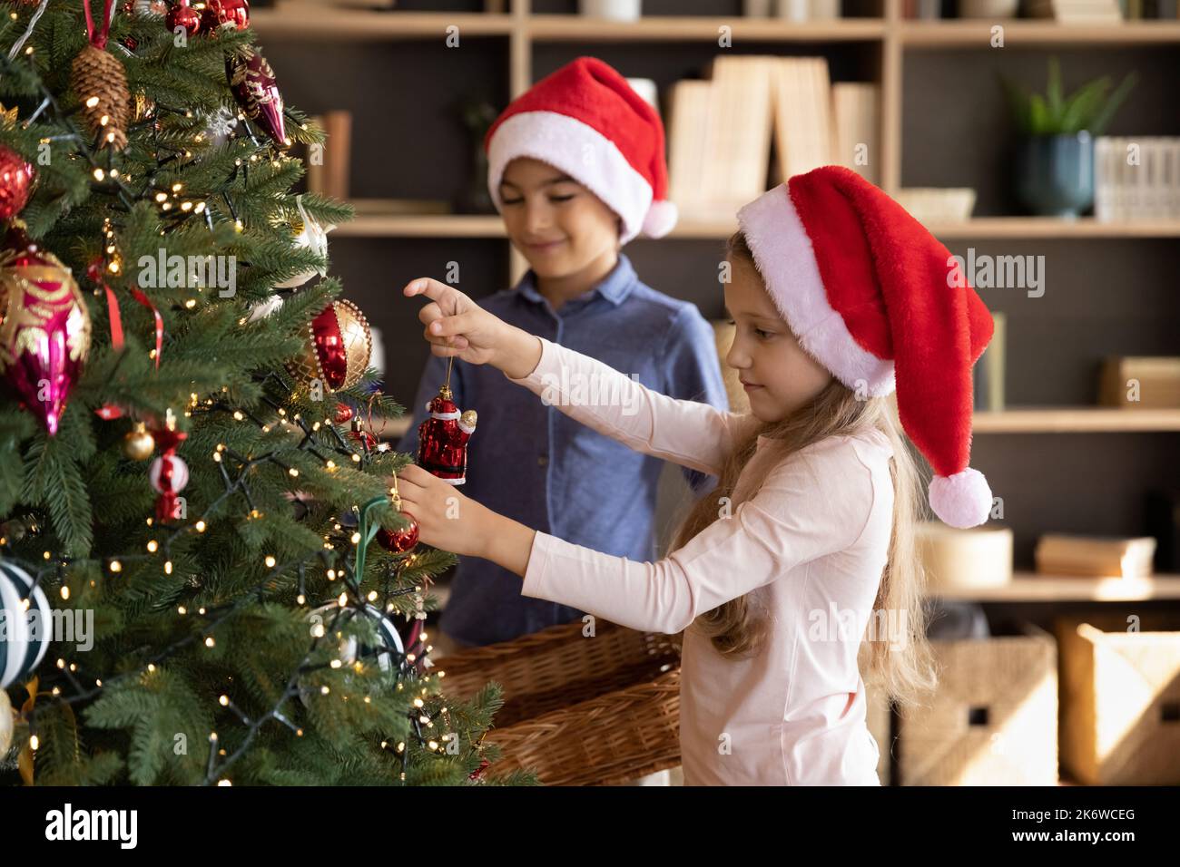 Little kids, brother and sister in Santa caps celebrating Christmas ...