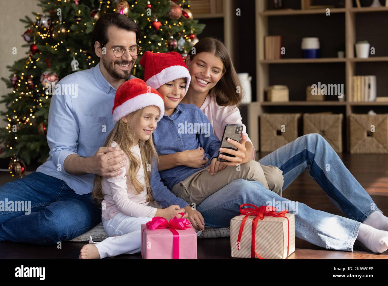 Cheerful two kids and parents talking on video phone call Stock Photo ...