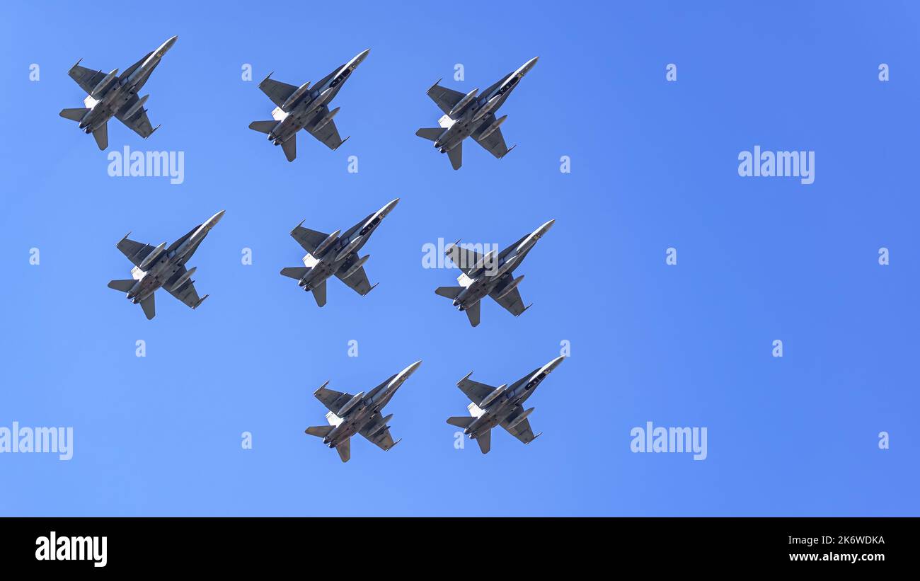 Group of supersonic aircraft in formation, flying close together in an ...