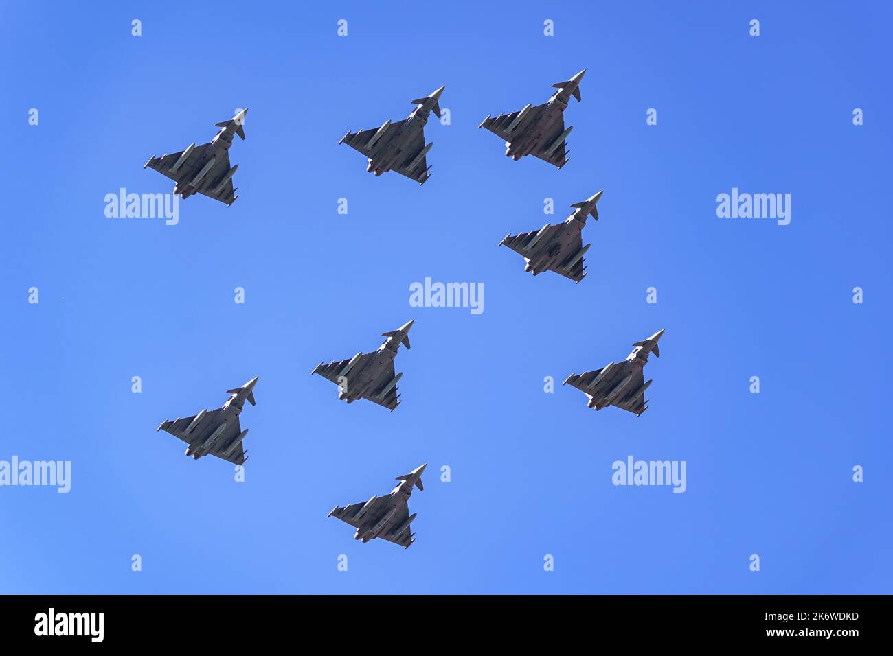 Group of supersonic planes in formation flying in the sky in a military ...