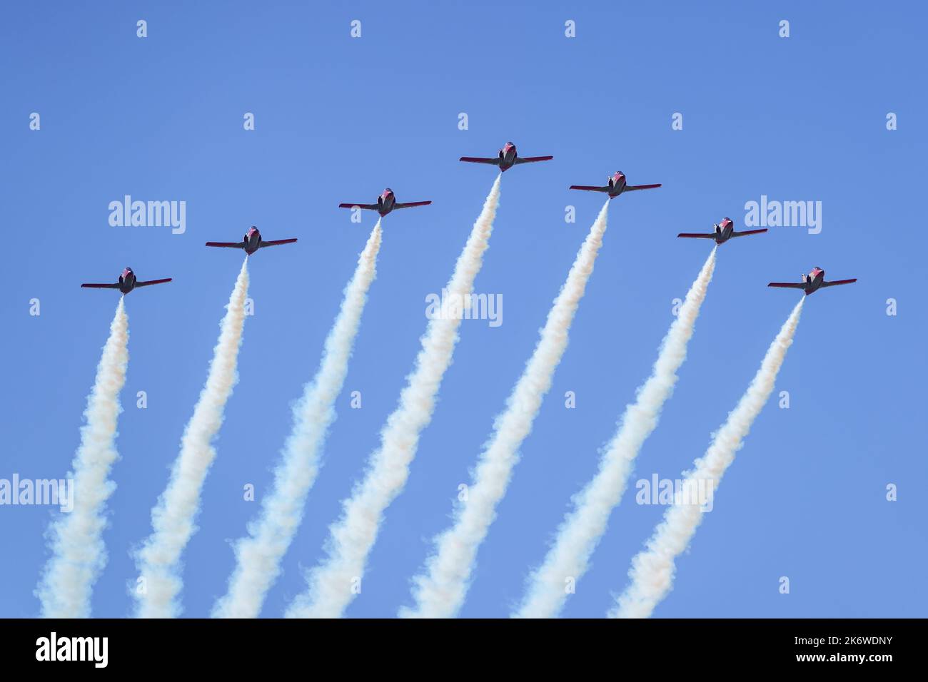 Group of aerobatics flying in formation close together and forming jets ...