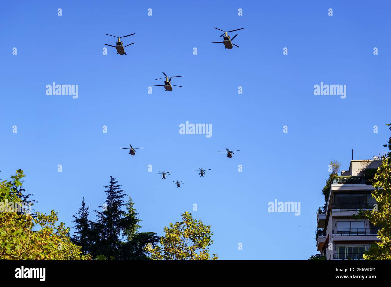 Group of helicopters flying low in formation in a military parade ...
