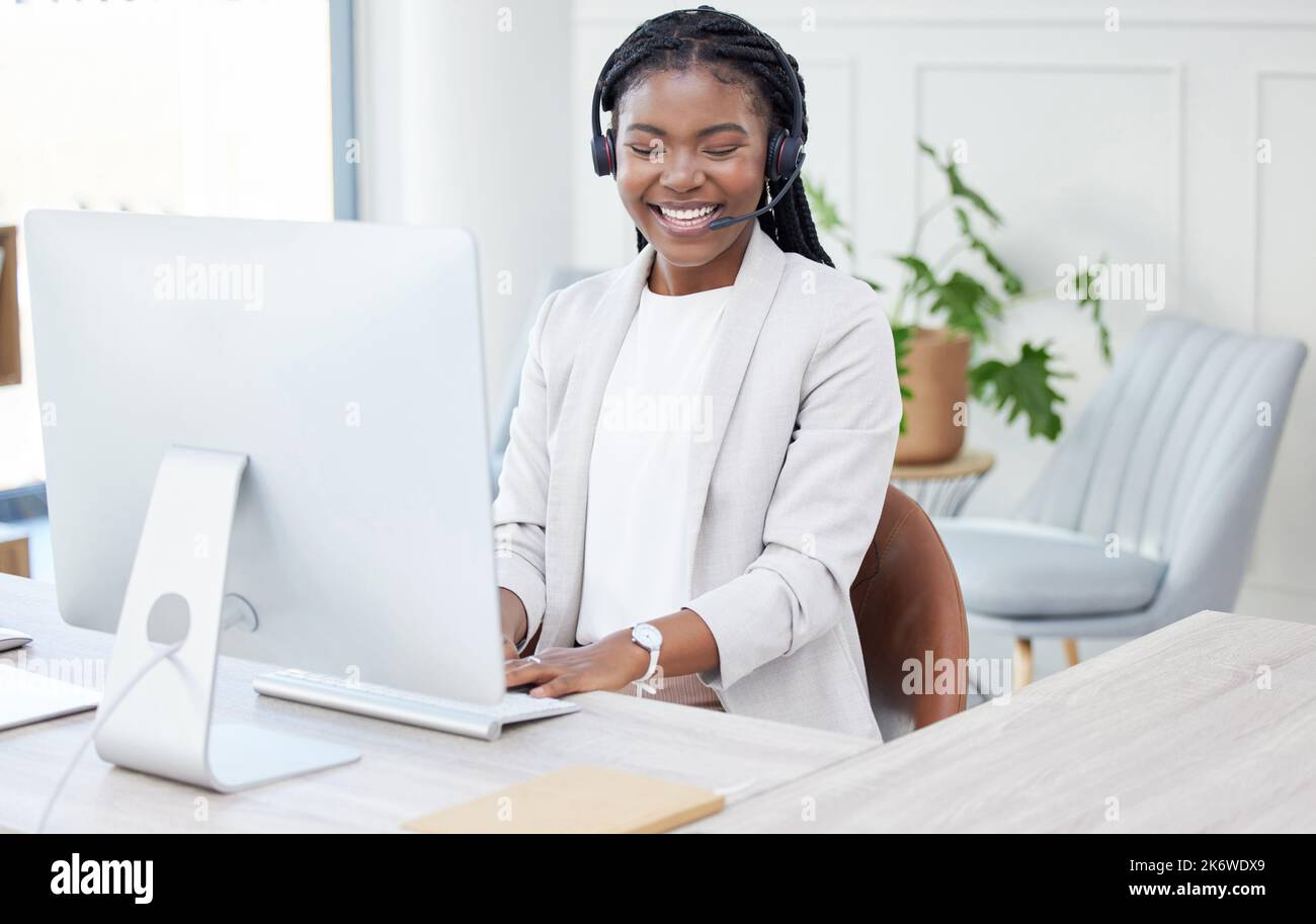 Always at your beck and call. a young african woman working on her PC ...