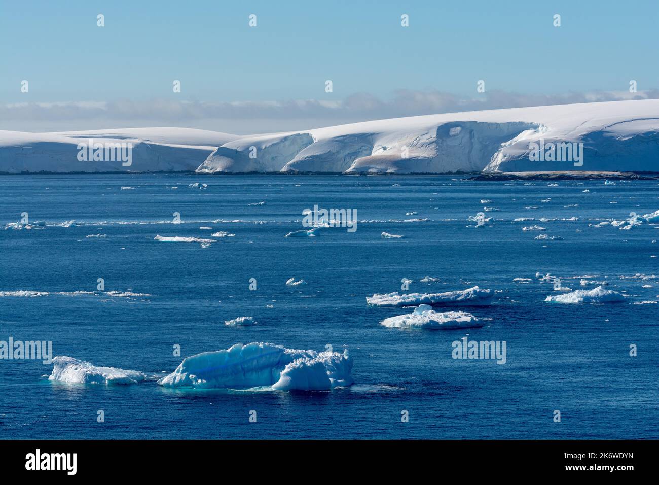 sea ice and icebergs in bismarck strait with snow covered shores of ...