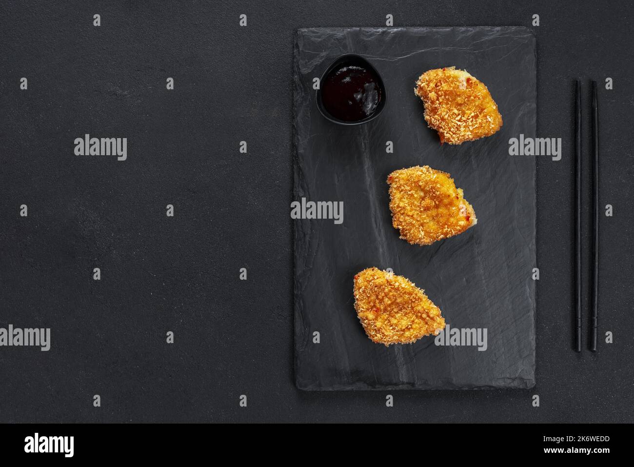 Chinese fried chicken nuggets in batter on a black background. Asian ...