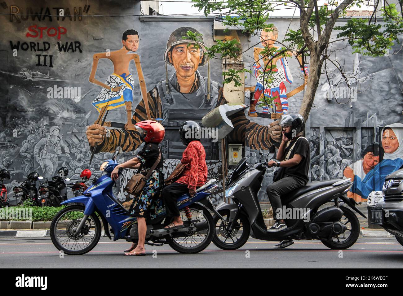 Solo, Central Java, Indonesia. 9th Oct, 2022. Residents pass in front ...