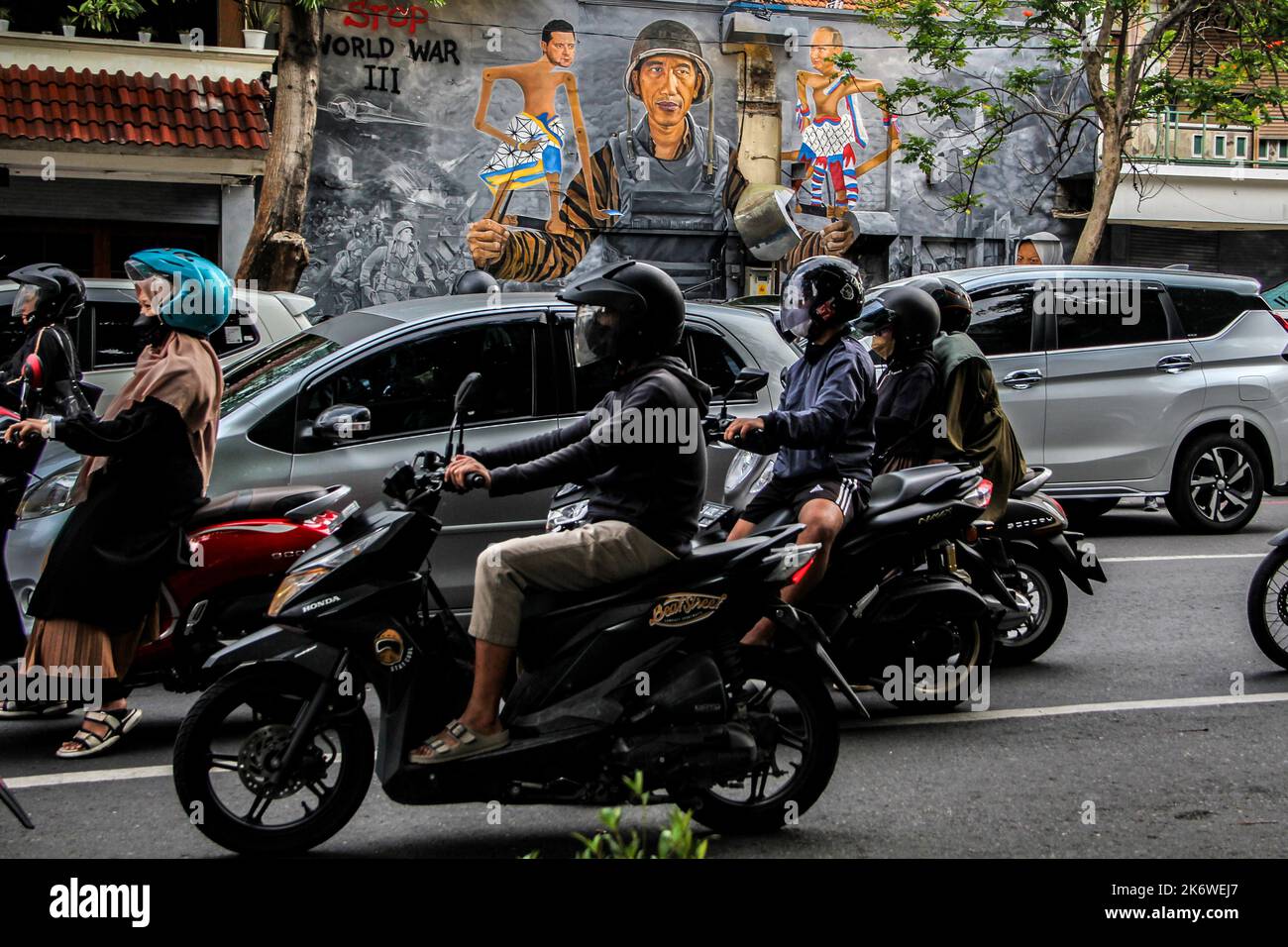 Solo, Central Java, Indonesia. 9th Oct, 2022. Residents pass in front ...