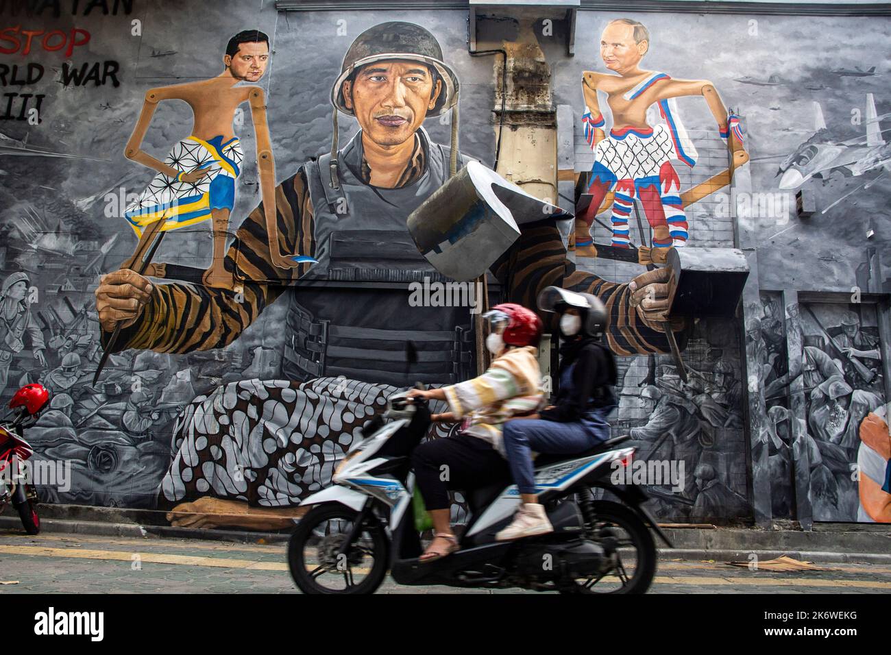 Solo, Central Java, Indonesia. 9th Oct, 2022. Residents pass in front ...