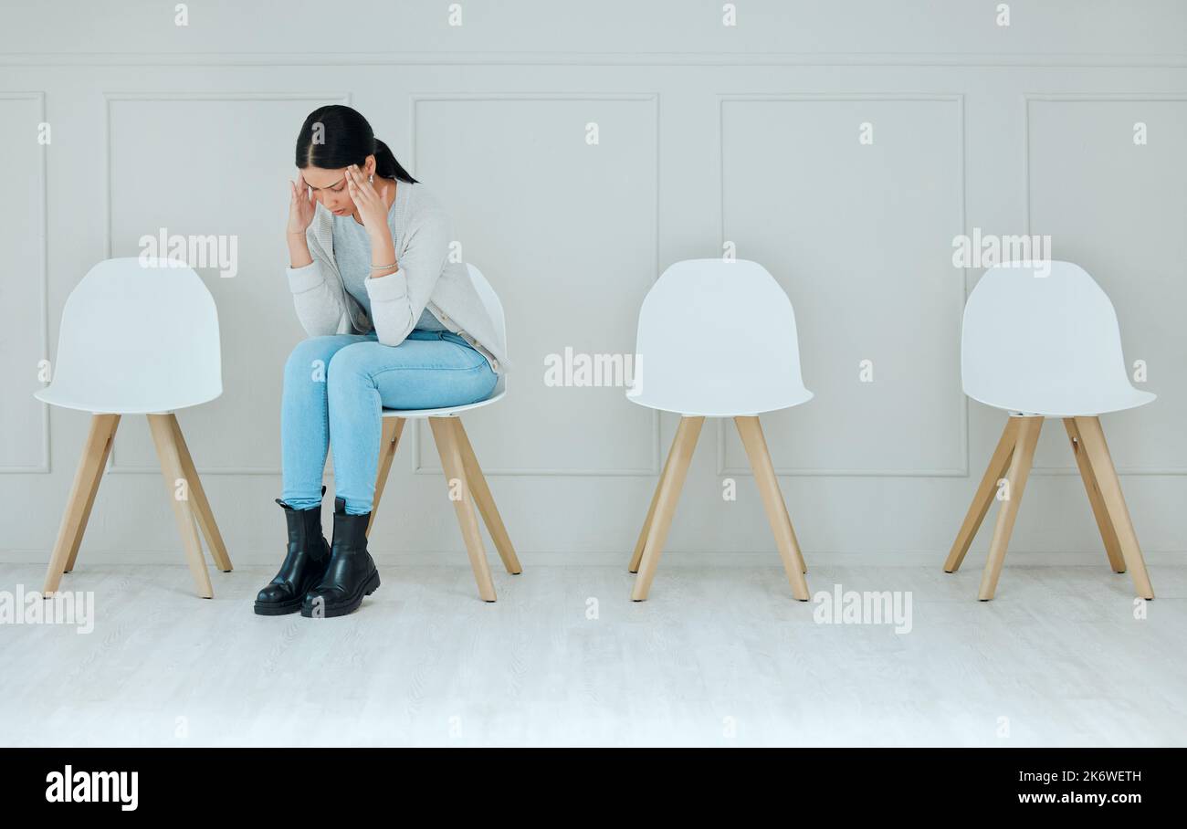 Overwhelming thoughts of failure. a young woman looking stressed while ...