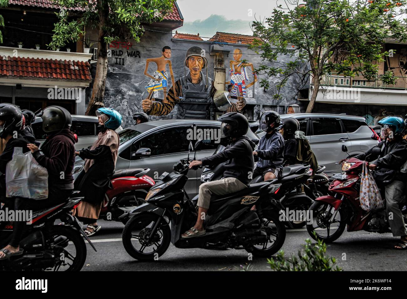 October 9, 2022, SOLO, CENTRAL JAVA, INDONESIA: Residents pass in front ...