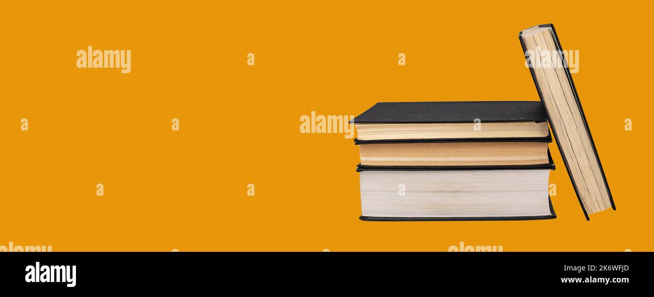 Paper books stack on ad banner, orange background with space for text ...