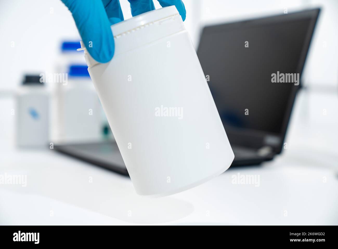 Plastic container for chemicals in science lab on computer background ...