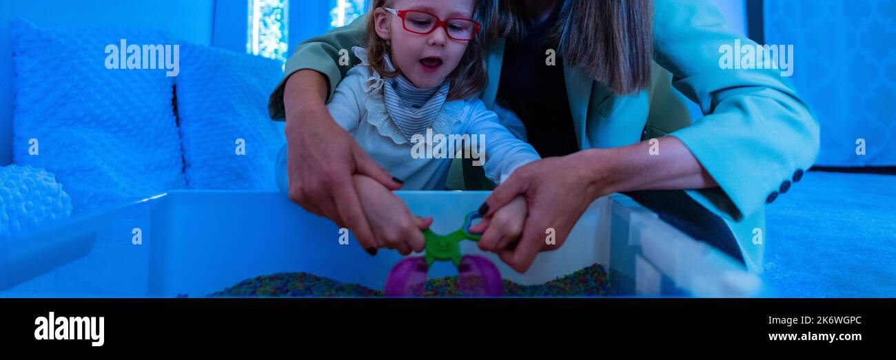 Child with physical disability in sensory stimulating room, snoezelen ...
