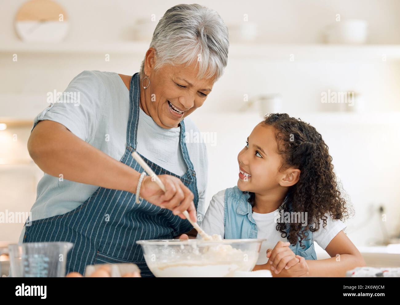 How do you get the cake so moist grandma. a little girl baking with her ...